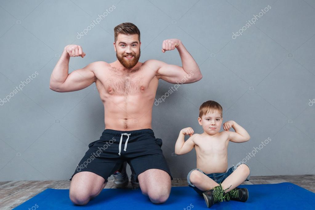 Cheerful father and his little son showing biceps Stock Photo by ...