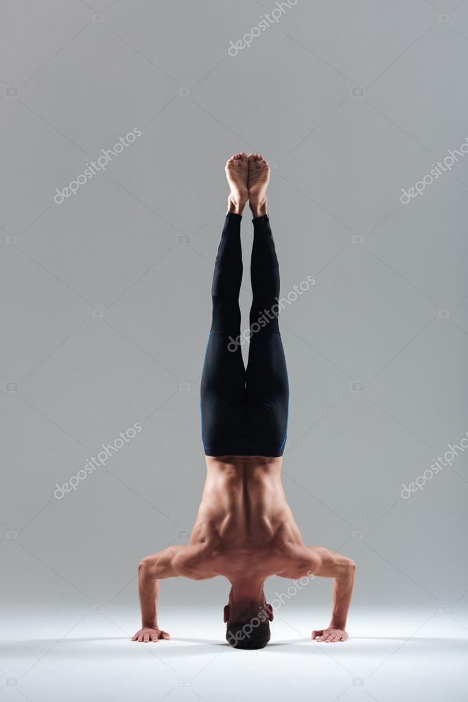 Man doing headstand Stock Photo by ©Vadymvdrobot 110621692