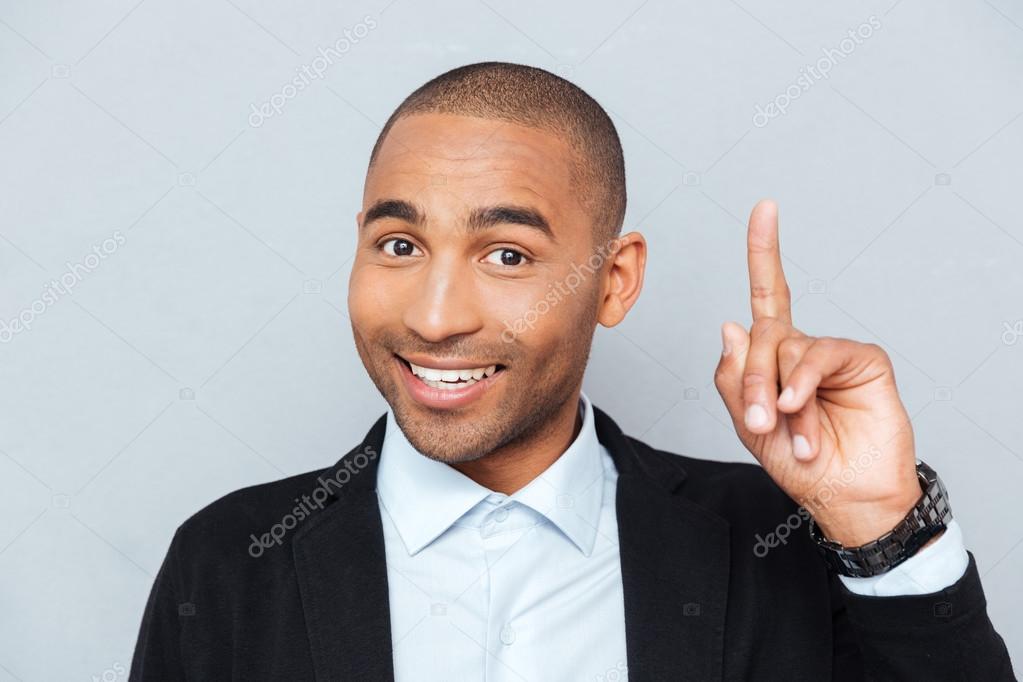 Close-up portrait of a happy man pointing finger up — Stock Photo ...