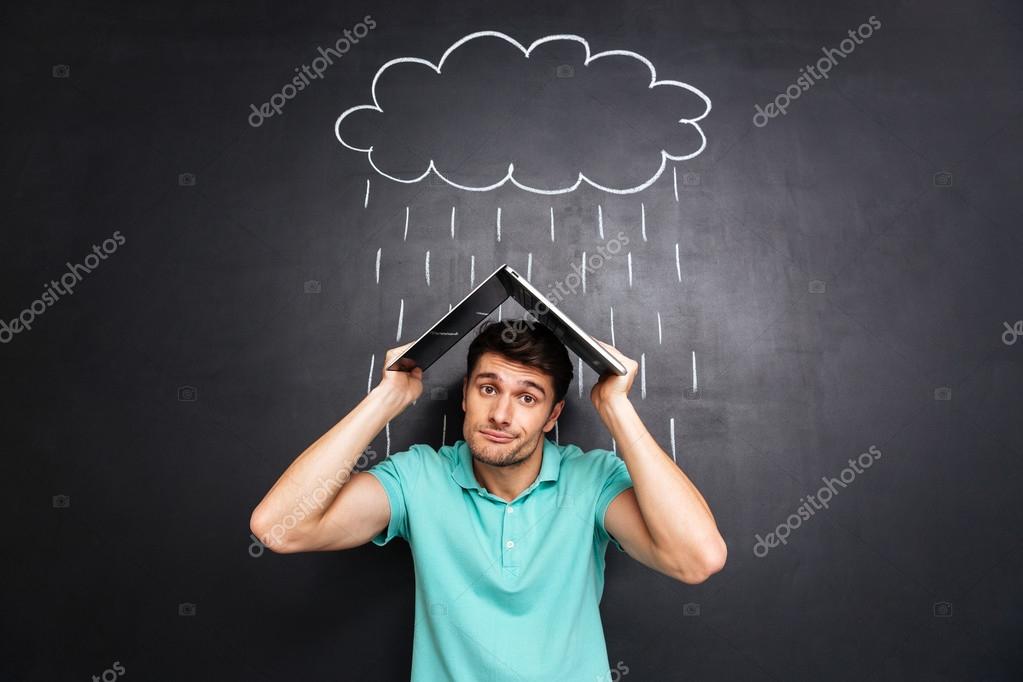 Man imitating roof with latop and covering from drawn rain — Stock ...