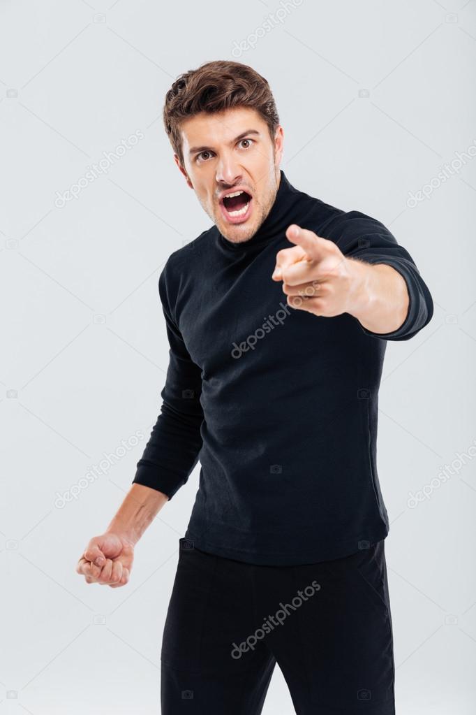 Angry furious young man shouting and pointing on you — Stock Photo ...
