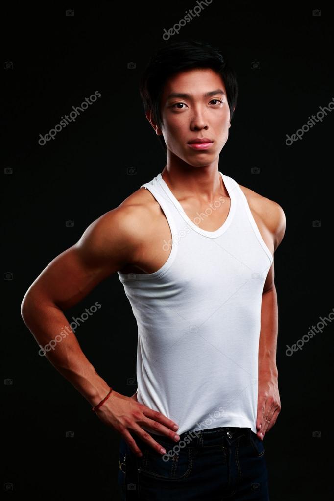 Handsome fit asian man isolated on black background Stock Photo by ...