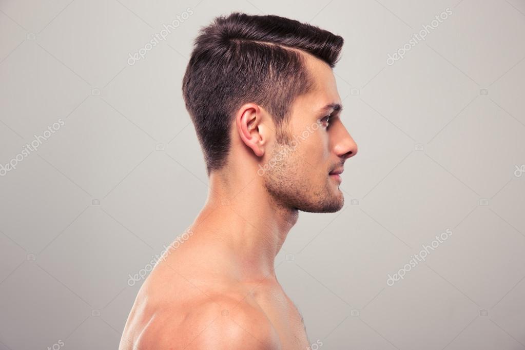 Side view portrait of a young man with nude torso Stock Photo by ...