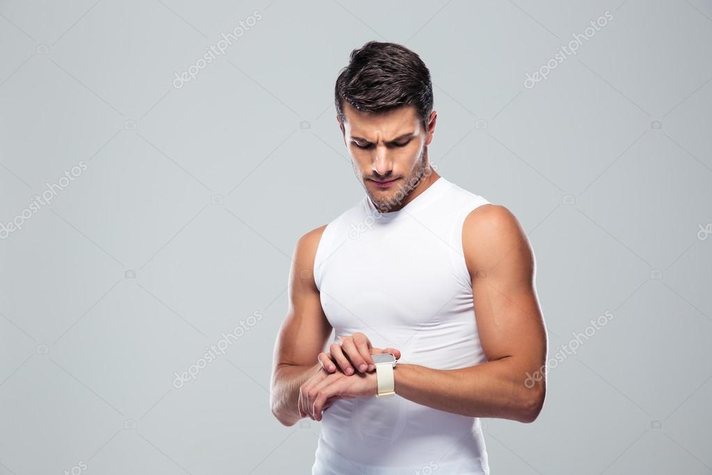 Handsome sports man using smart watch — Stock Photo © Vadymvdrobot ...