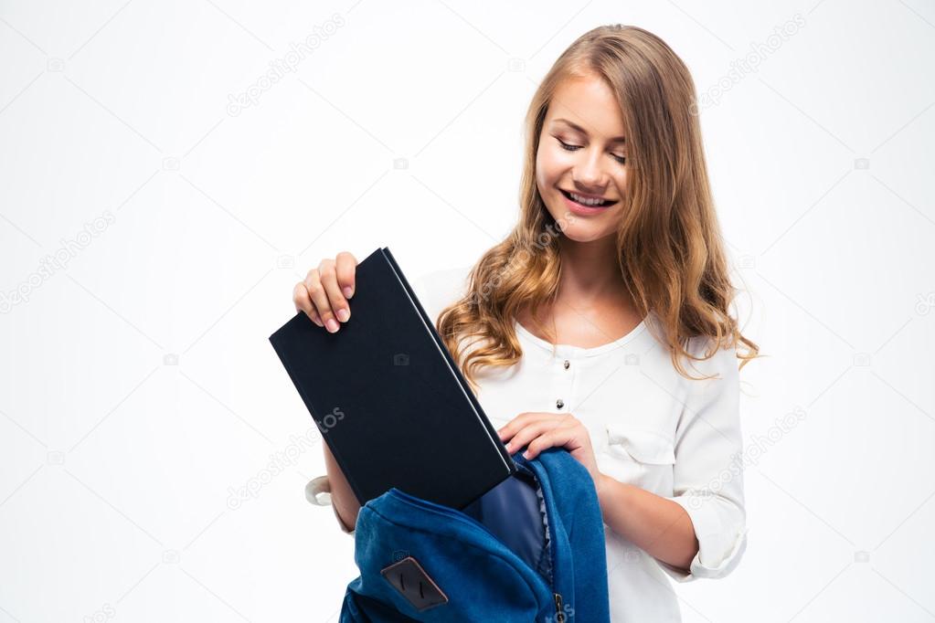 Woman putting book into backpack — Stock Photo © Vadymvdrobot #77913524