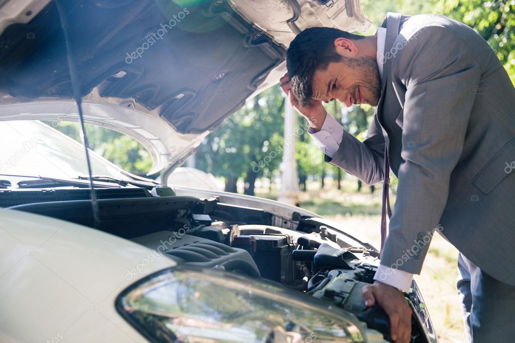 Man looking under the hood of car Stock Photo by ©Vadymvdrobot 79070000