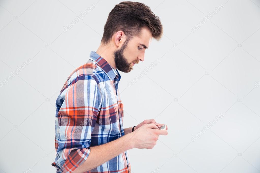 Side view portrait of a happy man using smartphone Stock Photo by ...