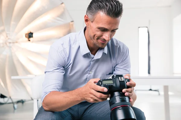 Happy photographer using camera - Stock Image - Everypixel