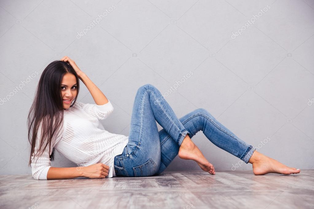 Smiling attractive woman lying on the floor — Stock Photo ...