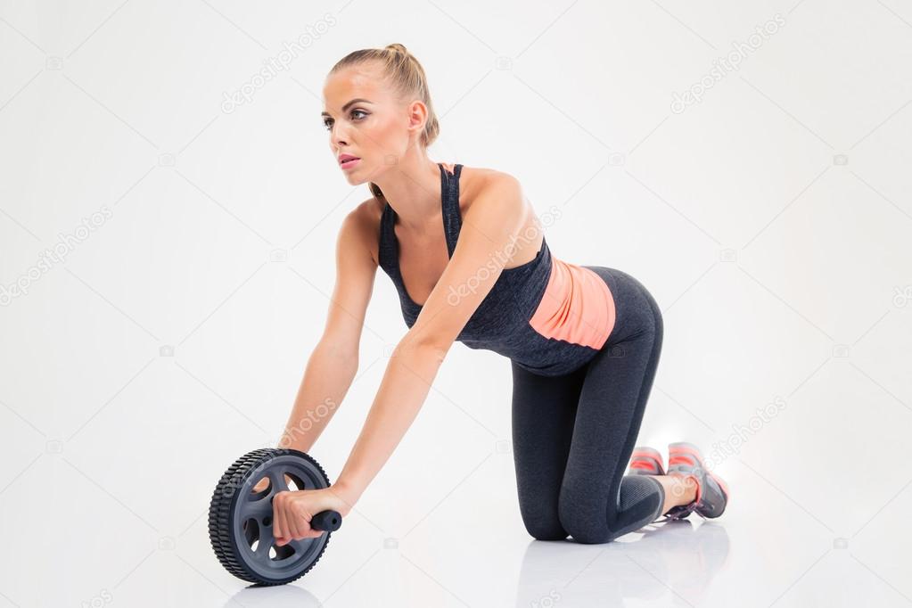 Woman workout with exercises wheel Stock Photo by ©Vadymvdrobot 83117420