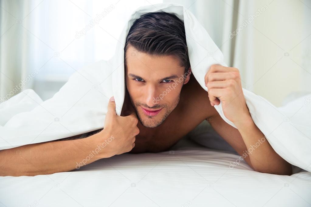 Handsome man lying under blanket in the bed Stock Photo by ... Handsome man lying under blanket in the bed Stock Photo by ...