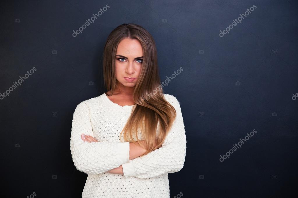 Angry woman standing with arms folded Stock Photo by ©Vadymvdrobot 86014608