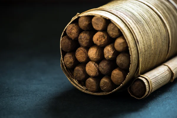 Pile of cigars in pal leafs crafted box Stock Photo by ©merc67 92331864