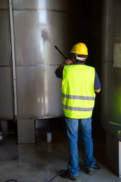 Worker in hard hat pressure washing Stock Photo by ©temis1964 59921813