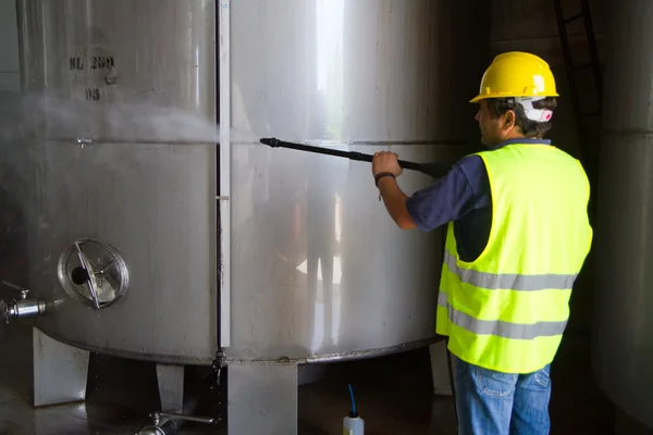 Worker in hard hat pressure washing Stock Photo by ©temis1964 59921813