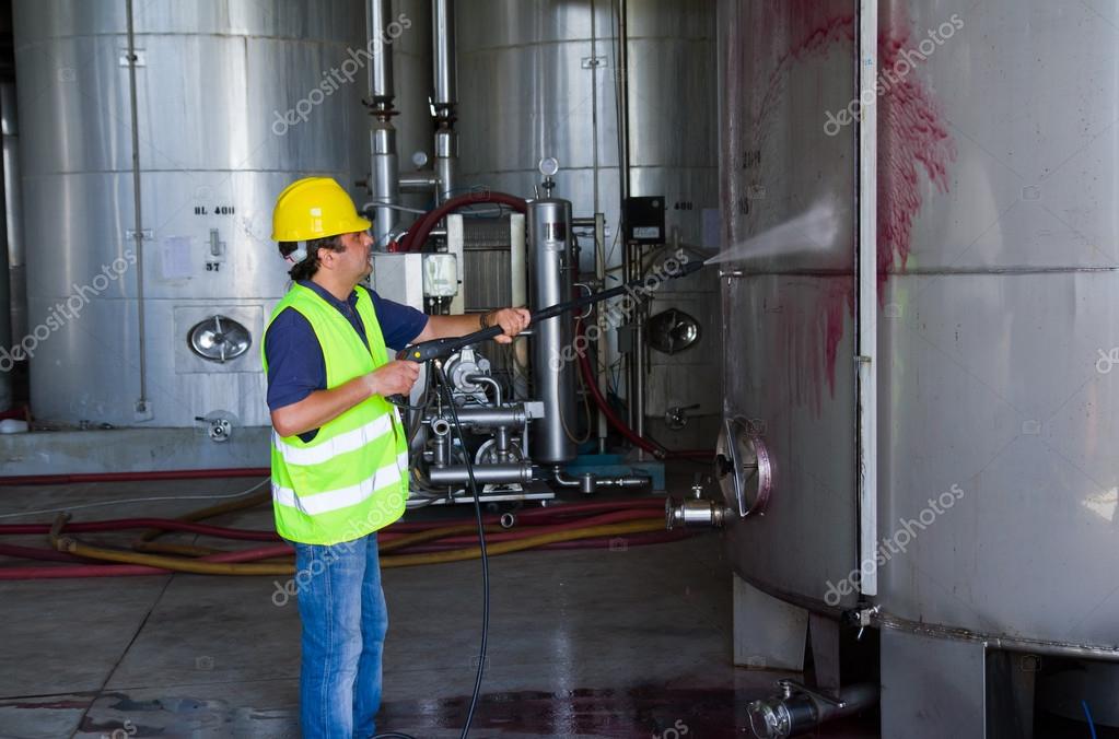 Worker in hard hat pressure washing Stock Photo by ©temis1964 59921813