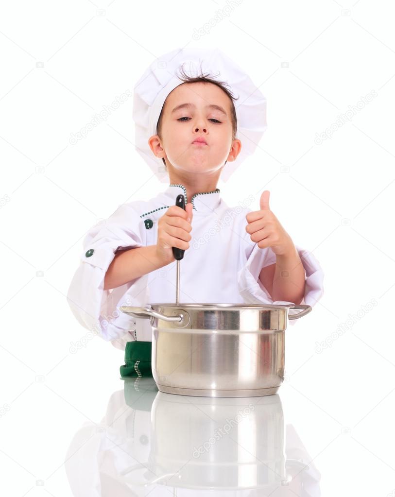 Little satisfied boy chef with ladle stirring in the pot — Stock Photo ...