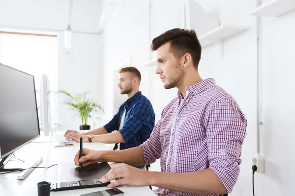 man or designer with computer and tablet at office - Stock Image ...