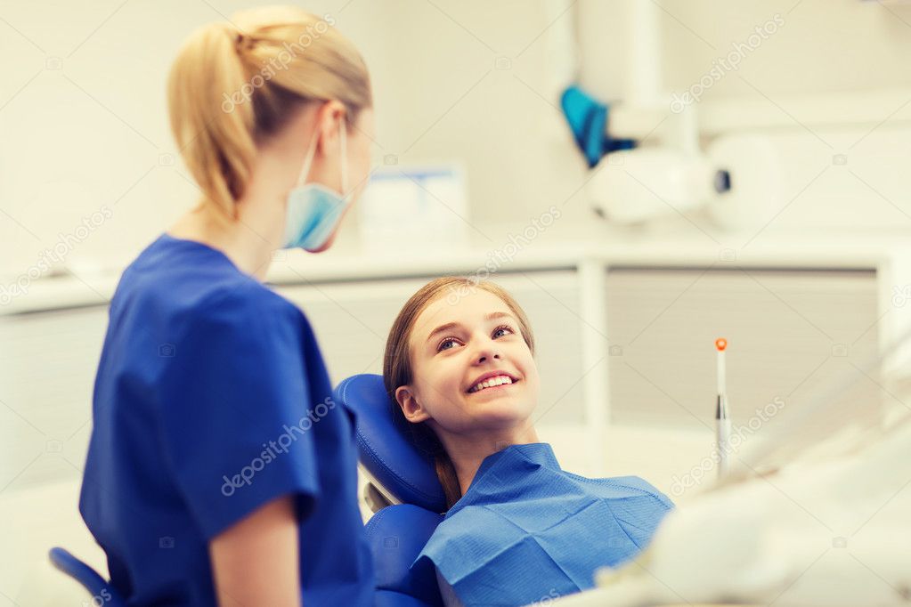 Happy female dentist with patient girl at clinic Stock Photo by ©Syda_Productions 111618426