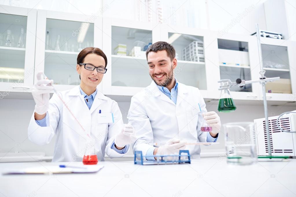 Young scientists making test or research in lab — Stock Photo © Syda ...
