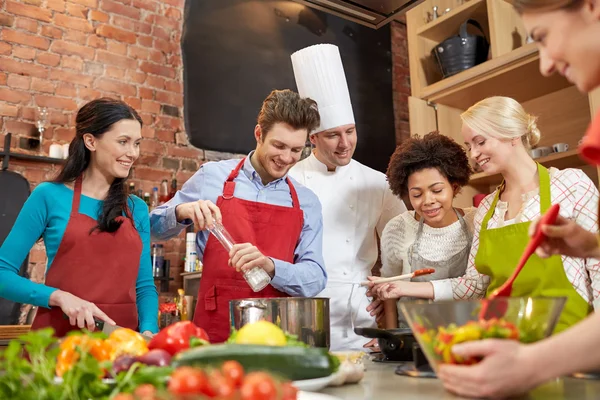 happy friends and chef cook cooking in kitchen - Stock Image - Everypixel