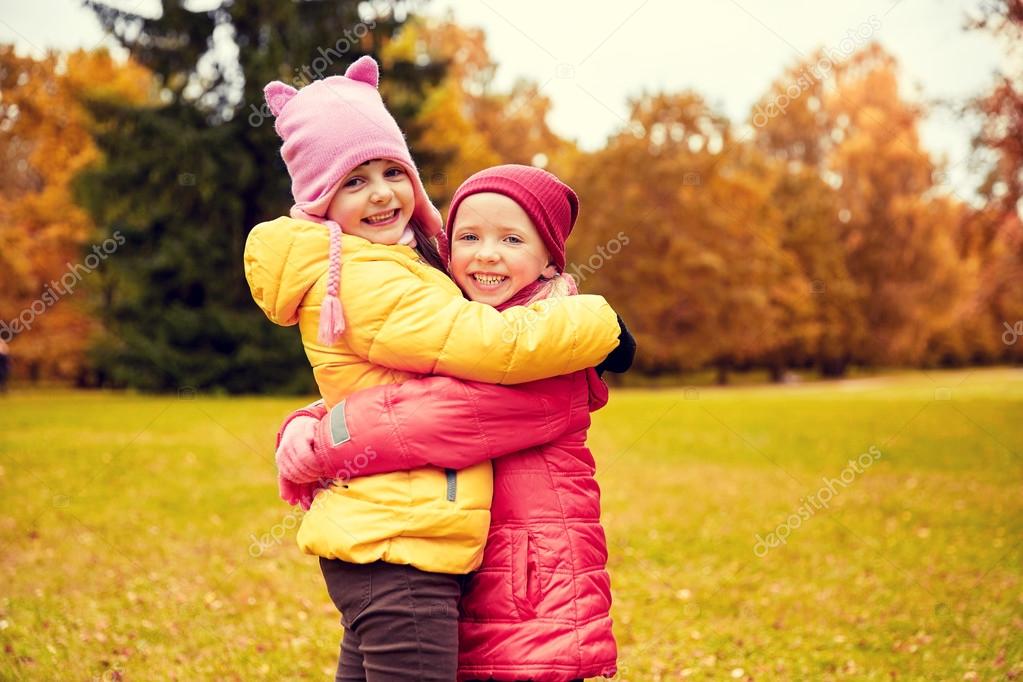 Two happy little girls hugging in autumn park — Stock Photo © Syda ...