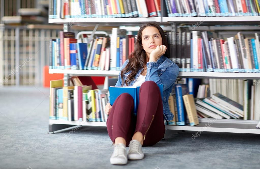 Girl Reading A Book In Library