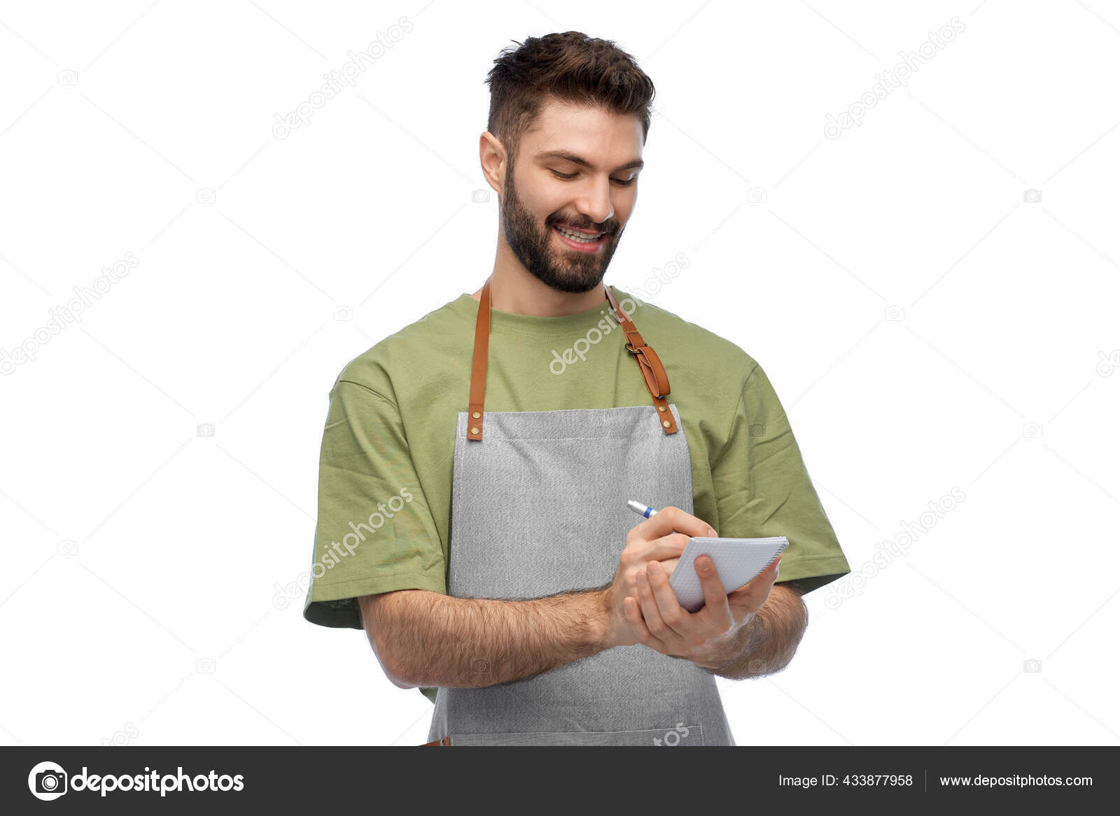 Smiling waiter in apron taking notes to notepad — Stock Photo © Syda ...