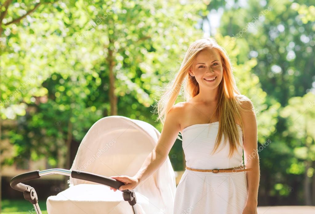 Happy mother with stroller in park — Stock Photo © Syda_Productions ...