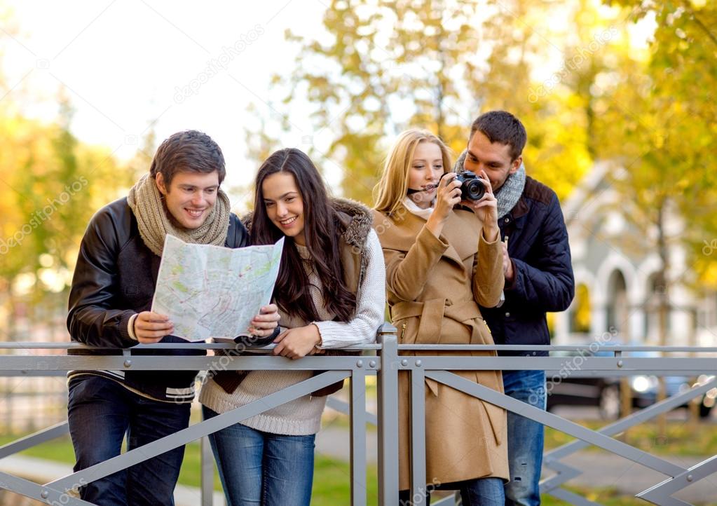 Group of friends with map and camera outdoors Stock Photo by ©Syda ...