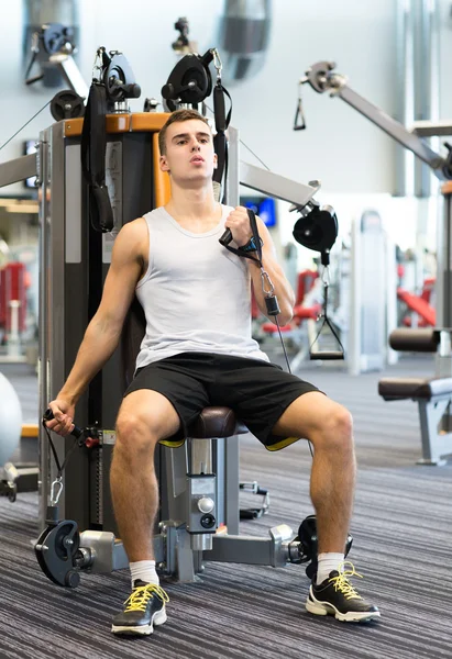 man exercising on gym machine - Stock Image - Everypixel
