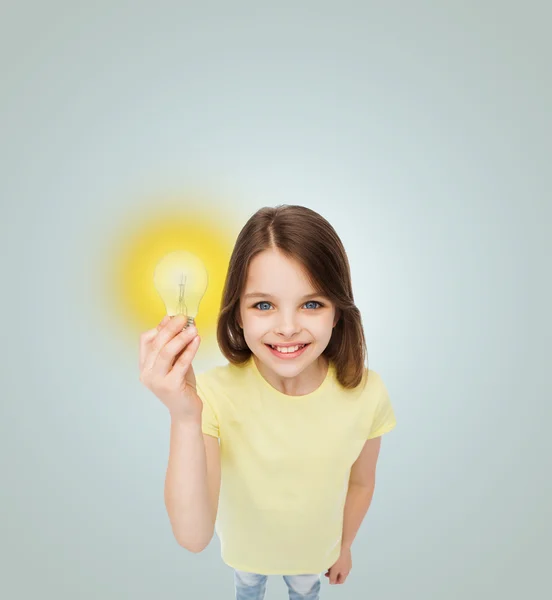 Smiling little girl holding light bulb Stock Photo by ©Syda_Productions ...