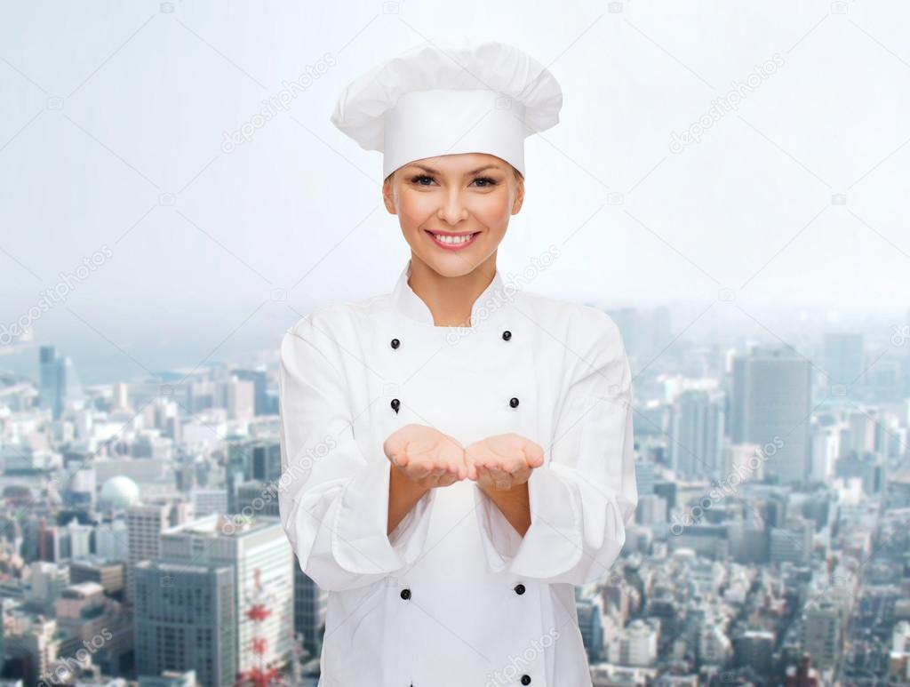 Smiling female chef holding something on hands Stock Photo by ©Syda ...
