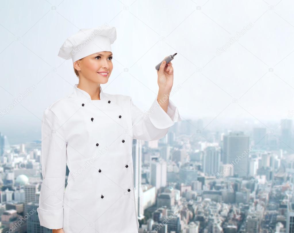 Smiling female chef writing something on air Stock Photo by ©Syda ...