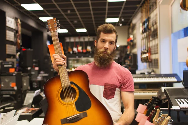 assistant or customer with guitar at music store - Stock Image - Everypixel