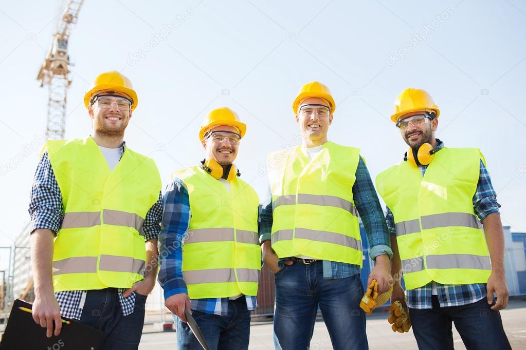 Group of smiling builders with tablet pc outdoors Stock Photo by ©Syda ...