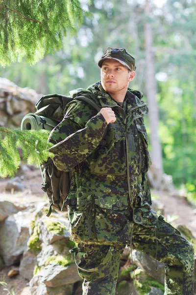 young soldier with backpack in forest - Stock Image - Everypixel