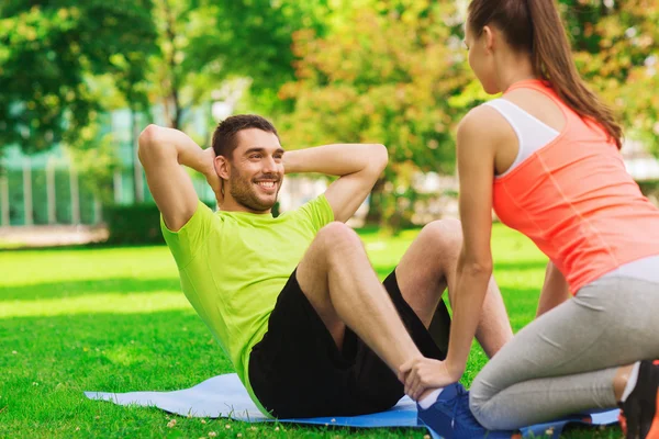 smiling man doing exercises on mat outdoors - Stock Image - Everypixel