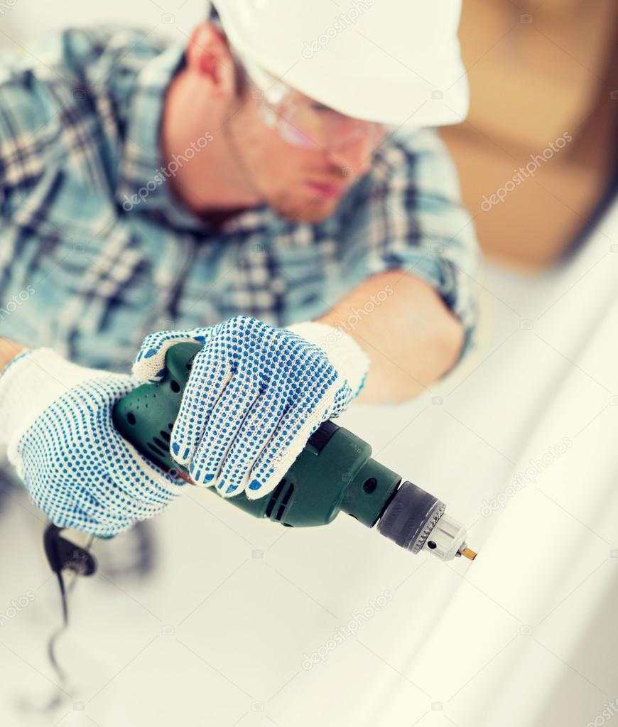 Man drilling hole in wall — Stock Photo © Syda_Productions #66814217