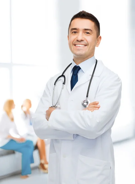 Smiling male doctor in white coat at hospital - Stock Image - Everypixel