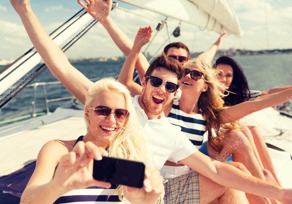 Smiling friends sitting on yacht deck — Stock Photo © Syda_Productions ...