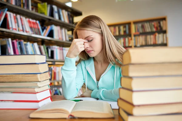 bored student or young woman with books in library - Stock Image ...