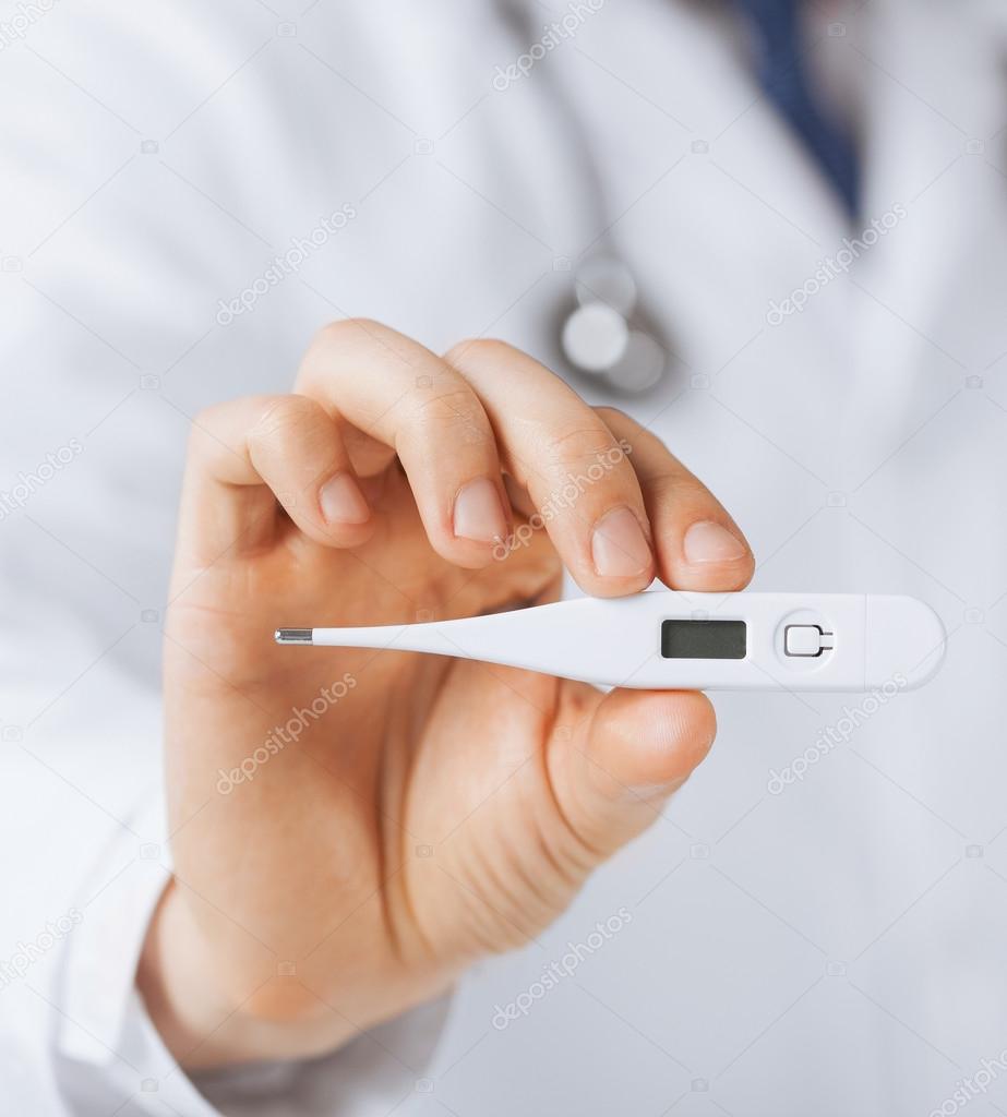 Male doctor with thermometer Stock Photo by ©Syda_Productions 72507877