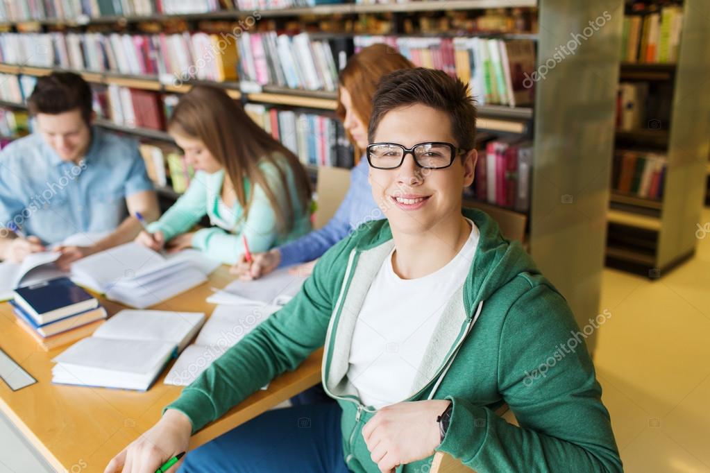 Happy student boy reading books in library Stock Photo by ©Syda ...