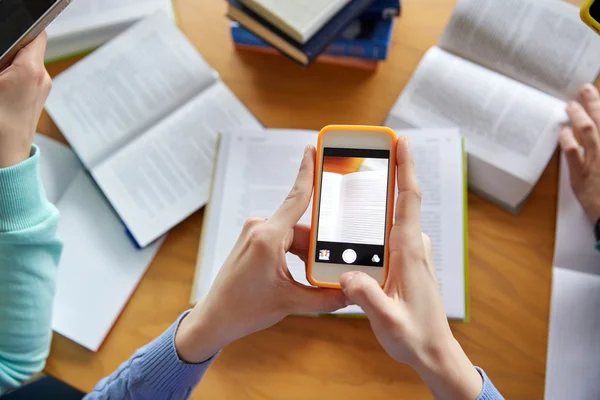 students with smartphones making cheat sheets - Stock Image - Everypixel