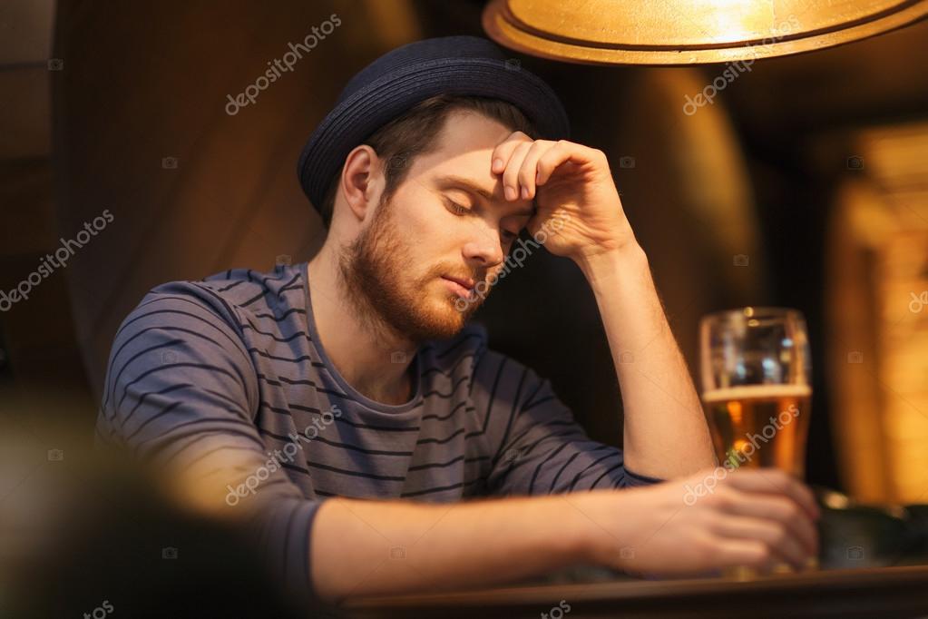 Unhappy lonely man drinking beer at bar or pub Stock Photo by ©Syda ...