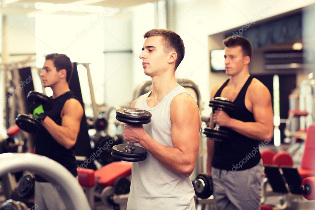 Group of men with dumbbells in gym Stock Photo by ©Syda_Productions ...