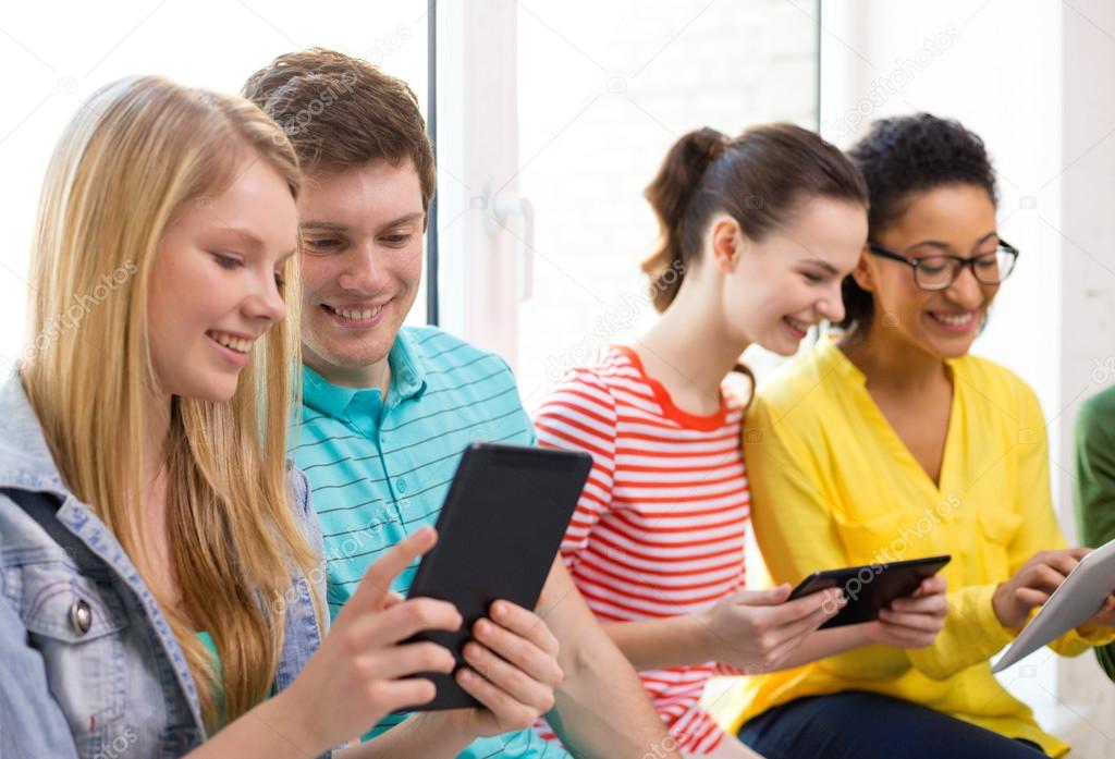 Smiling students with tablet pc at school — Stock Photo © Syda ...