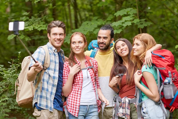 friends with backpack taking selfie by smartphone - Stock Image ...
