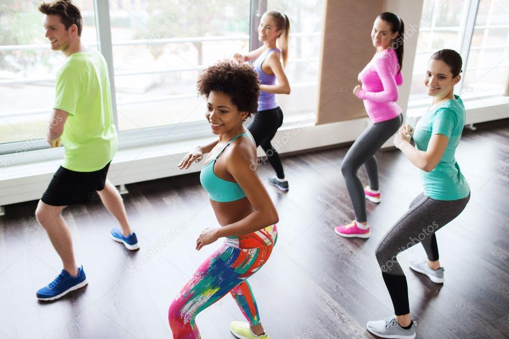 Group of smiling people dancing in gym or studio — Stock Photo © Syda ...